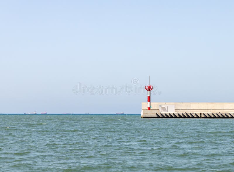 A Small Lighthouse is Located on the Breakwater at the Exit from the ...