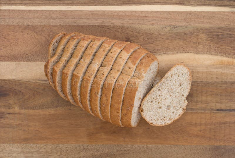 Small Loaf of Sliced Wheat Bread on a Cutting Board Stock Photo - Image ...