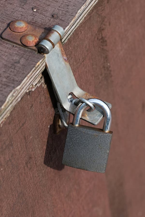 A Metal Lock with a Set of Keys on the Background of a Wood Veneered ...