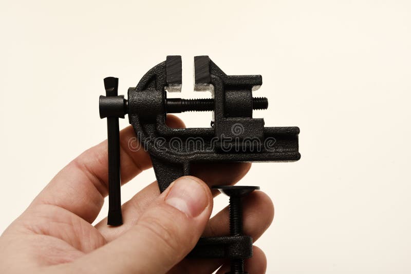 A Small Metal Vise in His Hand. the Clamp Stock Image - Image of hard ...