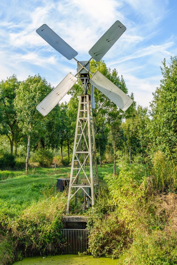 Small Metal Windmill Controls the Water Level in the Ditch. Stock Photo ...