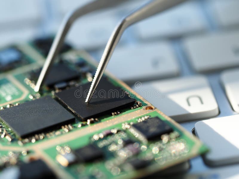 Small Microchip Board with Tweezers Lying on Silver Keyboard Stock ...