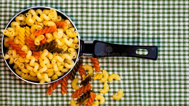 Small Mini Frying Pan with Tricolor Raw Fusilli Pasta in a Rustic ...