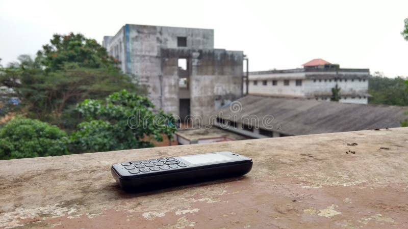A Small Mobile Phone Placed on the Top of a Building Stock Image ...