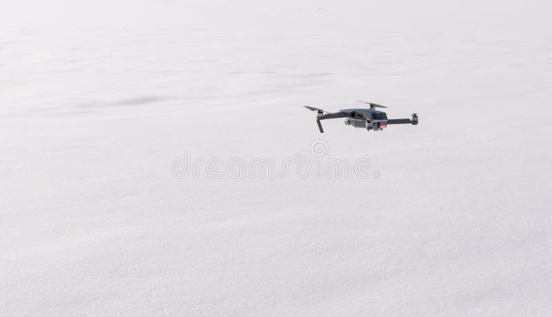 Small Modern Drone Hovering Against White Snow Stock Photo - Image of ...