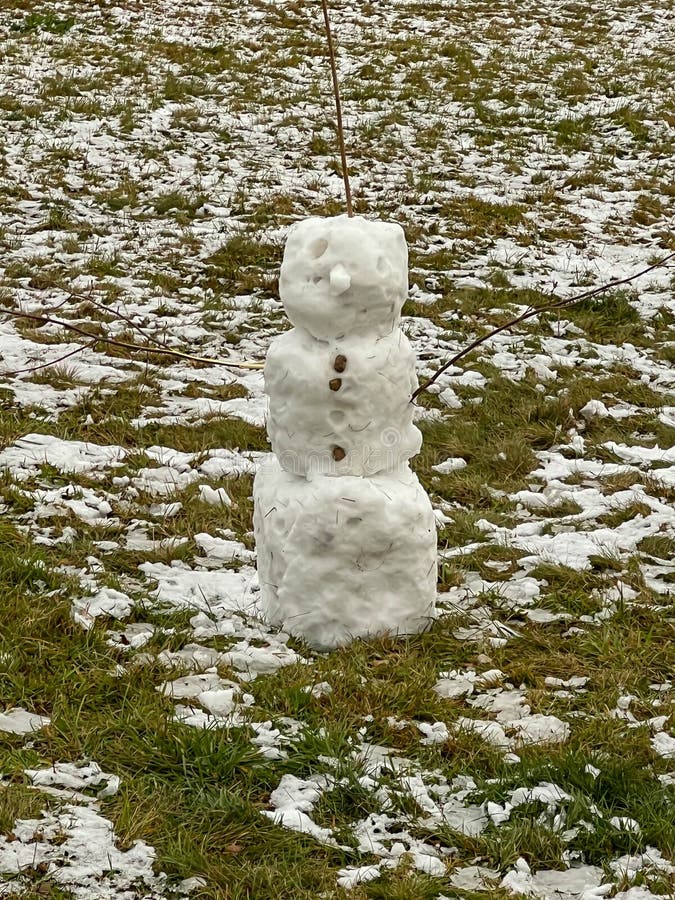 A Small, Modest Snowman Placed in a Meadow Made of Leftover Snow Stock ...