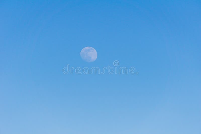 A Small Moon Far Away on Blue Sky in Evening Time As a Background ...