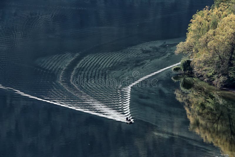 Small Motor Boat with Wide Wake Vortex by River Bend Stock Photo ...