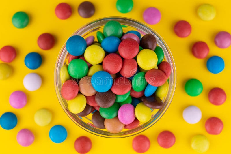 Small Multi-colored Sweets in a Bowl on a Yellow Background. Stock ...