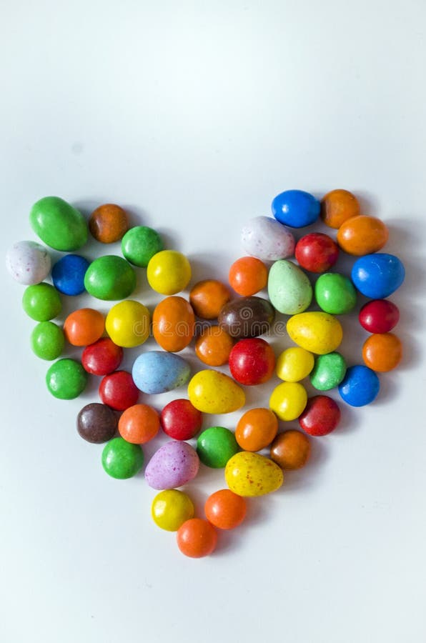Small Multi-colored Sweets in the Form of a Heart on a White Background ...