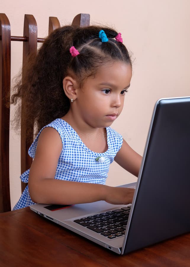 Small Multiracial Girl Working on a Laptop Computer Stock Photo - Image ...