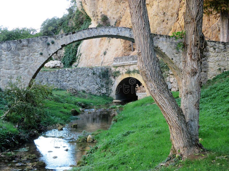 The Small and Narrow River Flows Under the Two Bridges. Stock Photo ...