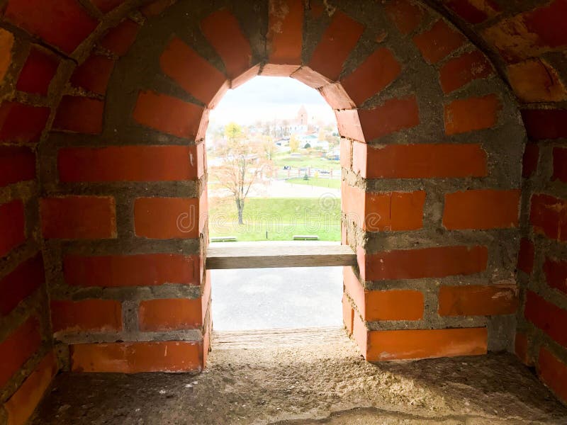 A Small Narrow Window on an Old Ancient Stone Thick Brick Wall in an ...