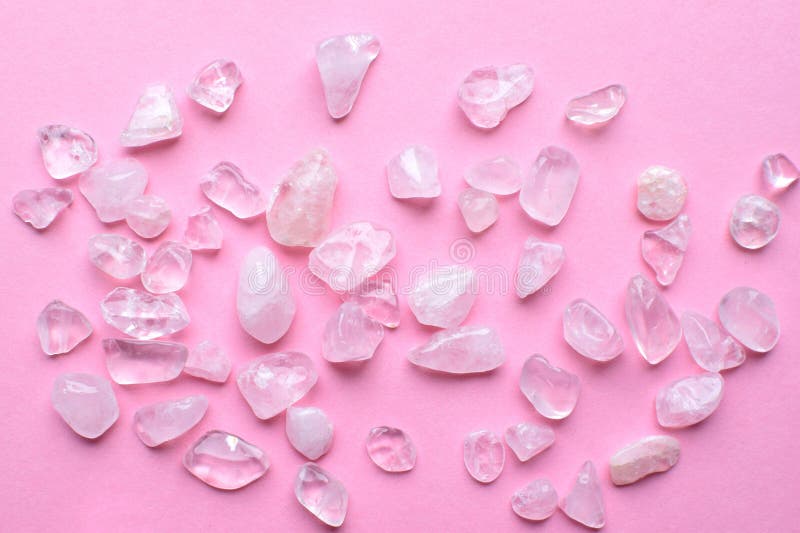 Small Natural Rose Quartz Stones Scattered on a Pink Background Stock ...