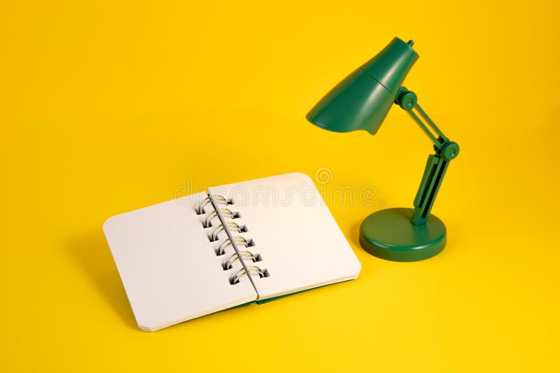 Small Notebook Mockup with a Toy Lamp on Yellow Background Stock Image ...