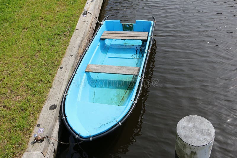 A Small Old Broken Turquoise Boat is Moored in the Small River at the ...