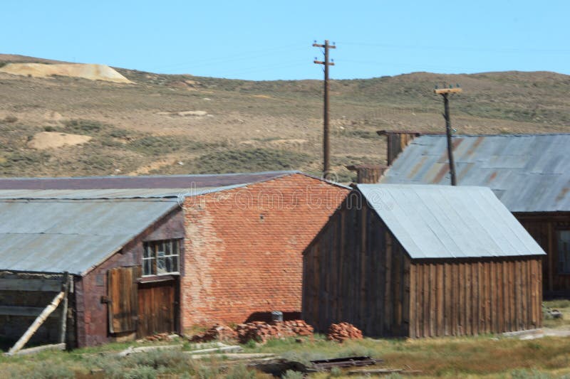 A Small, Old Building with a Brick Wall and a Tin Roof Stock Image ...