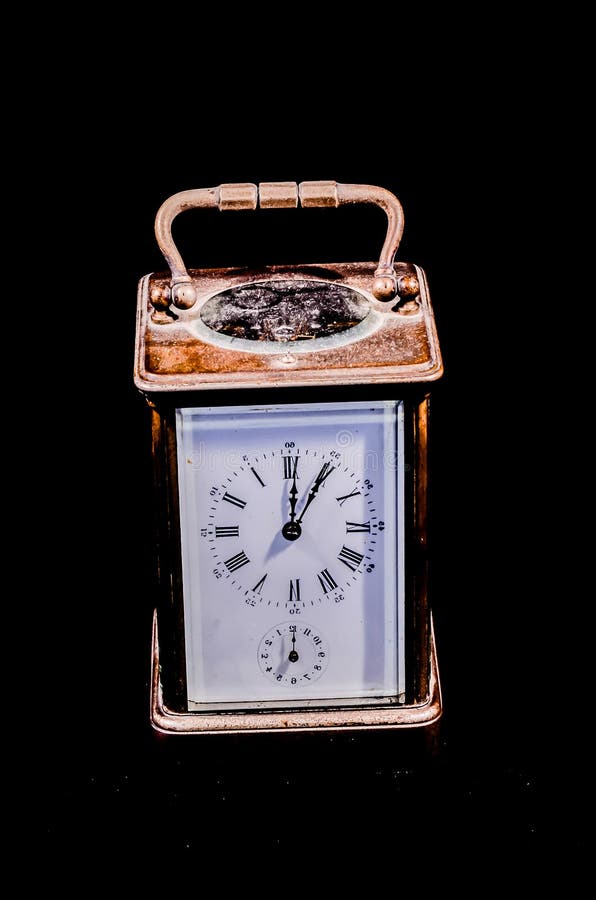 A Small, Old Fashioned Clock with Roman Numerals on the Face Stock ...