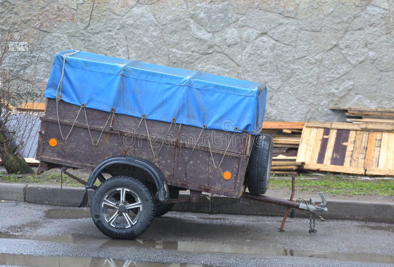 Small Old Rusty Cargo Trailer for a Car Stands Near the Wall Stock ...