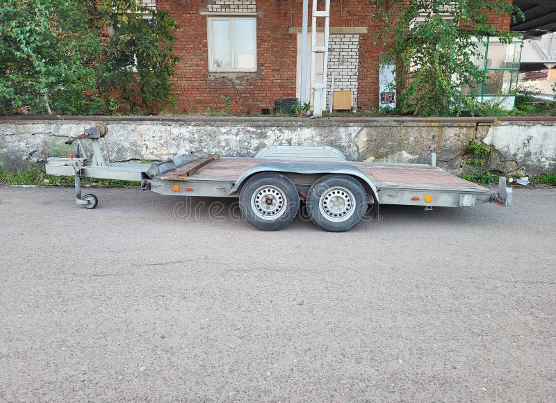 A Small Open Empty Cargo Trailer is Parked in the Yard. Stock Photo ...