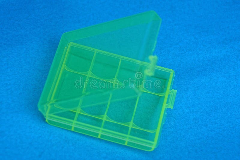A Small Open Green Plastic Box is on a Blue Table Stock Photo - Image ...