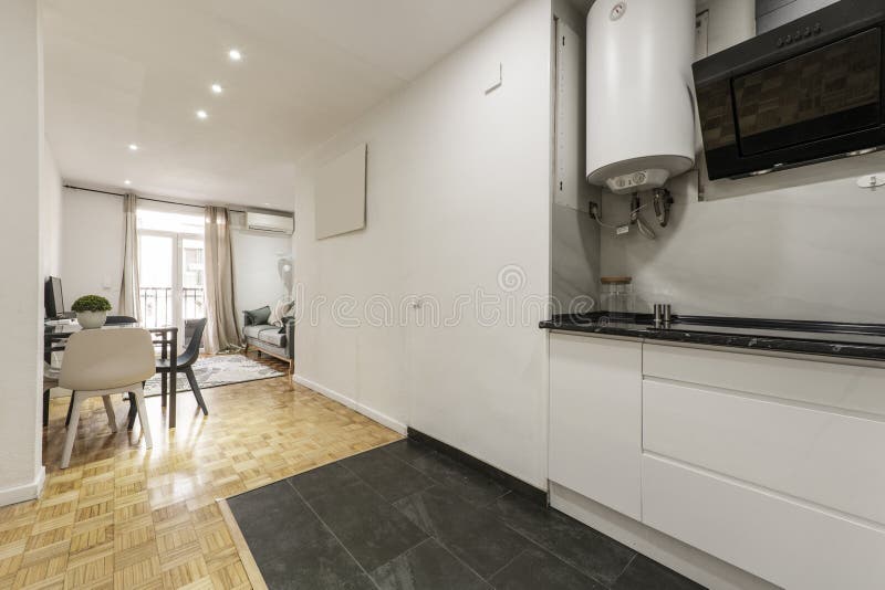 Small Open Plan Kitchen of a Studio Apartment with Dining Table and ...