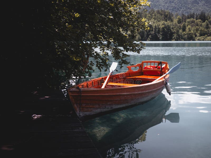 Small Orange Boat on a Serene Lake Stock Image - Image of nautical, boat: 317631335