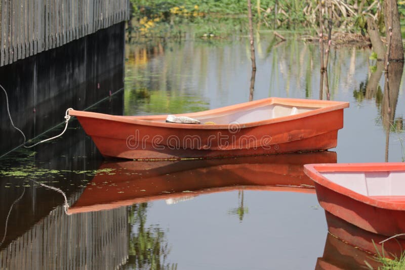 A Small Orange Plastic Boat Used for Flooding in Thailand. Stock Photo ...