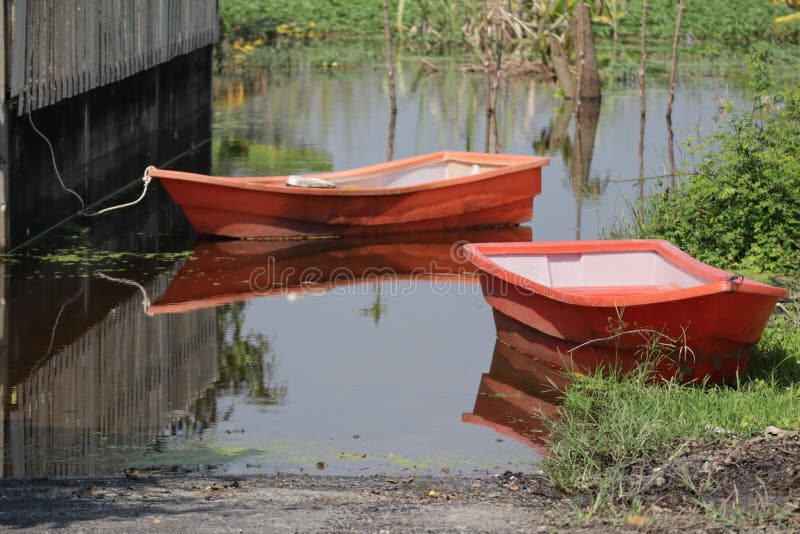 A Small Orange Plastic Boat Used for Flooding in Thailand. Stock Photo ...