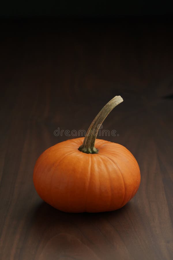 Small Orange Pumpkin for Halloween on Wood Table Stock Photo - Image of ...