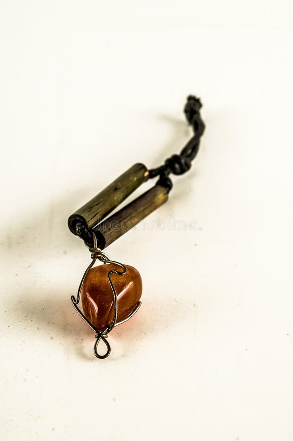 A Small Orange Stone is Hanging from a Chain Stock Image - Image of ...