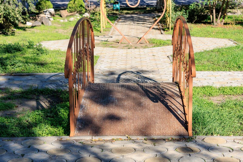 Small Ornamental Garden Bridge in a Sunlit Park Setting Stock Image ...