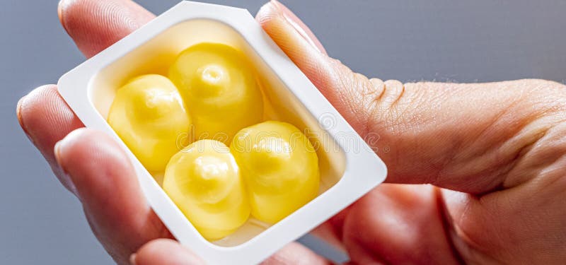 Small Packet of Butter in Hand on the Plane Stock Image - Image of ...