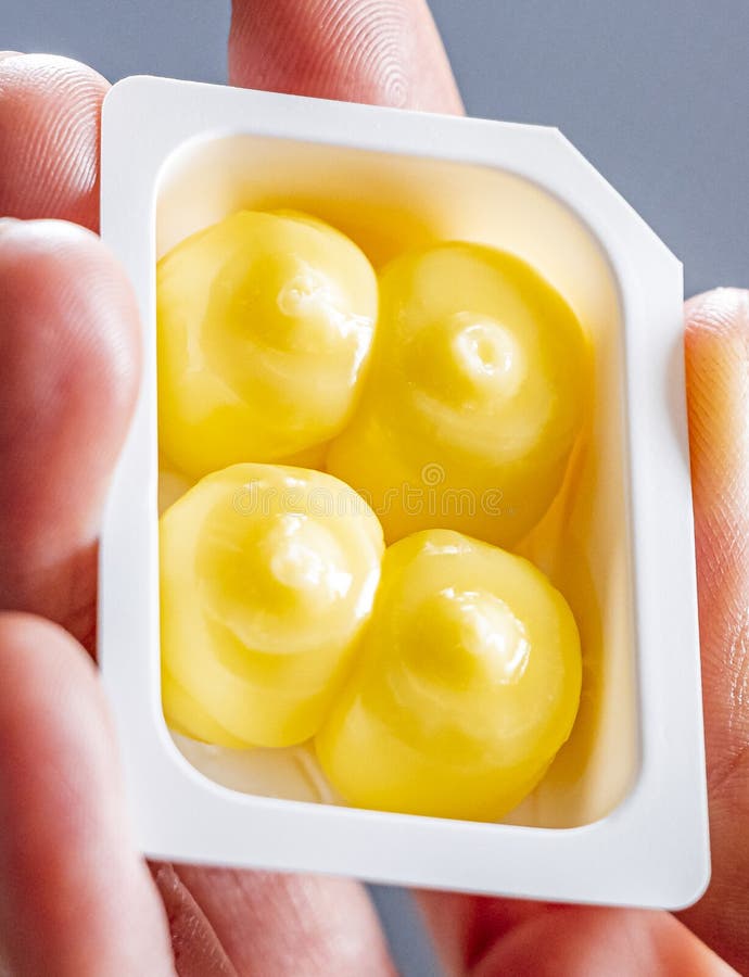 Small Packet of Butter in Hand on the Plane Stock Photo - Image of ...