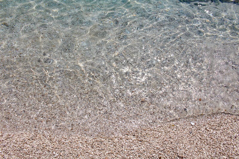 Small Pebbles on the Seashore. Small Pebbles on Beach. Clear Sea Water ...