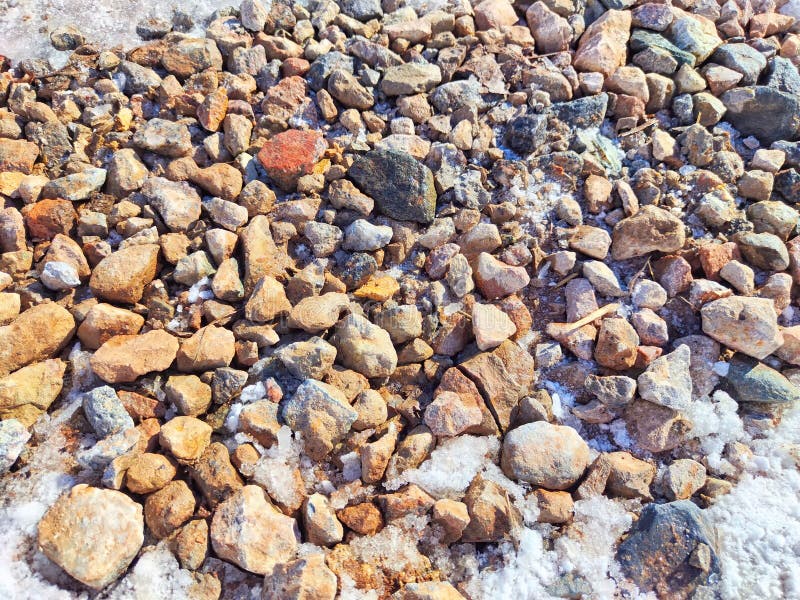 Small Pebbles in the Snow As a Background and Texture. Heart-Shaped ...