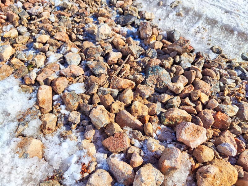 Small Pebbles in the Snow As a Background and Texture. Heart-Shaped ...