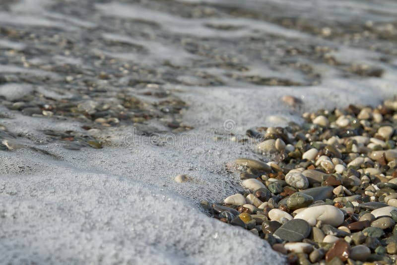 Small pebbles and waves stock image. Image of water, waves - 40914679