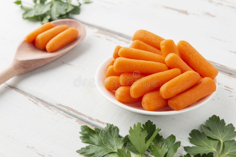 Small Peeled Pieces of Carrot in Plate on White Wooden Table Stock ...