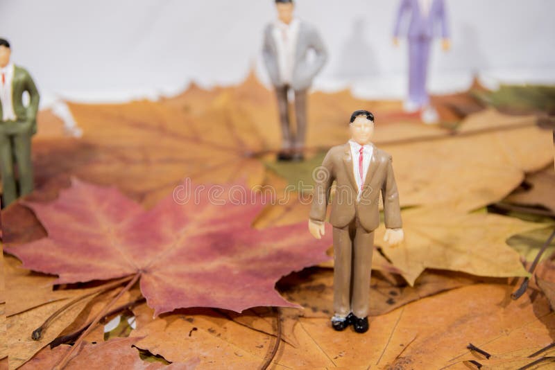 Small People Figures on Autumn Maple Leaves. Abstract Photo of Autumn ...