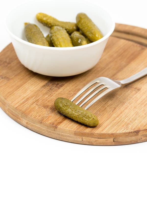 Small Pickles in the White Bowl and Pickle on the Fork Stock Photo ...