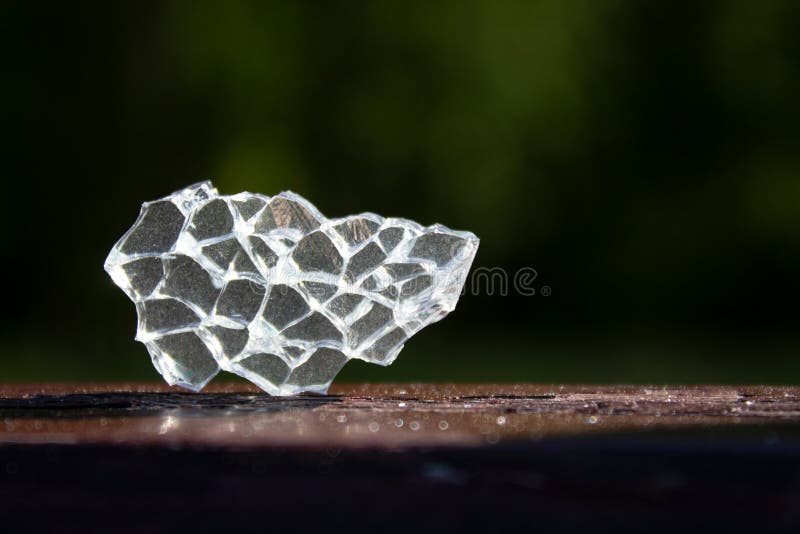 A Small Piece of Cracked Glass on a Wooden Texture. Broken Glass ...