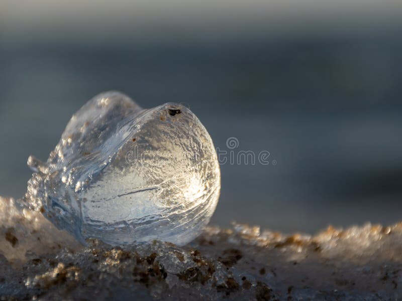A small piece of ice glows stock photo. Image of winter - 154858506