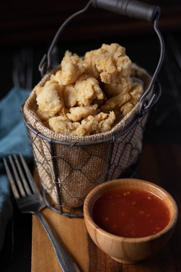 Small Pieces of Crispy Fried Chicken with Spicy Dipping Sauce in a Wire ...