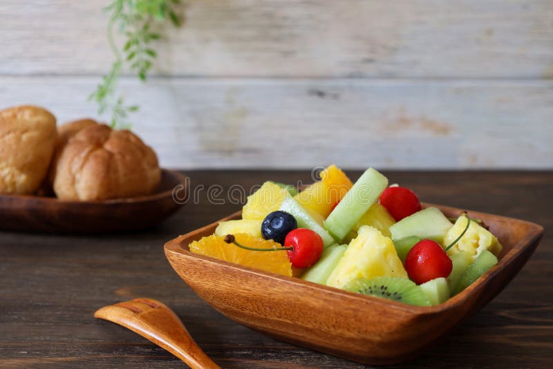 Small Pieces of Fruit Cut Up on a Wooden Bowl Stock Image - Image of ...