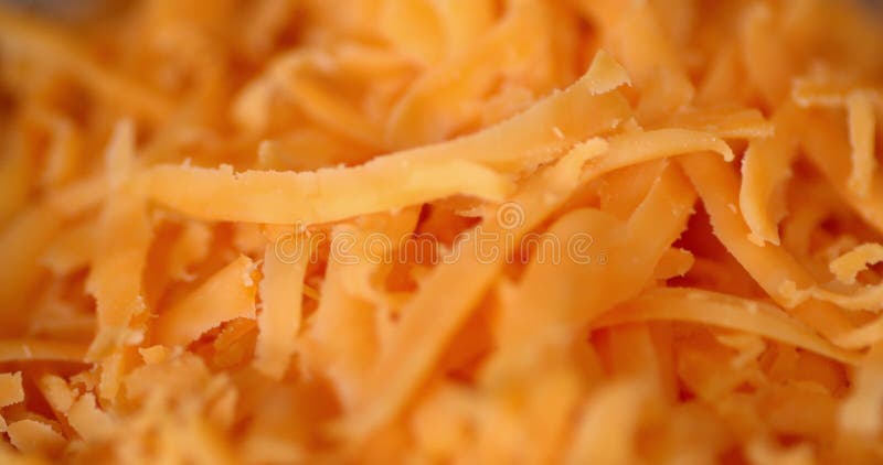 Small Pieces Grated Cheddar Cheese Fall in a Heap. Stock Footage ...