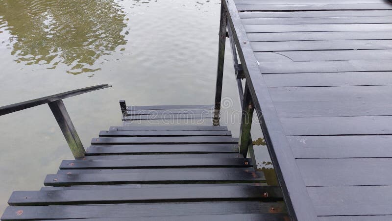 Small pier on the seafront stock photo. Image of flooring - 267109216