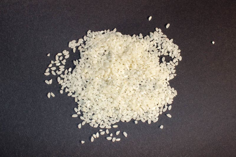 A Small Pile of White Round Rice on a Black Background Stock Photo ...