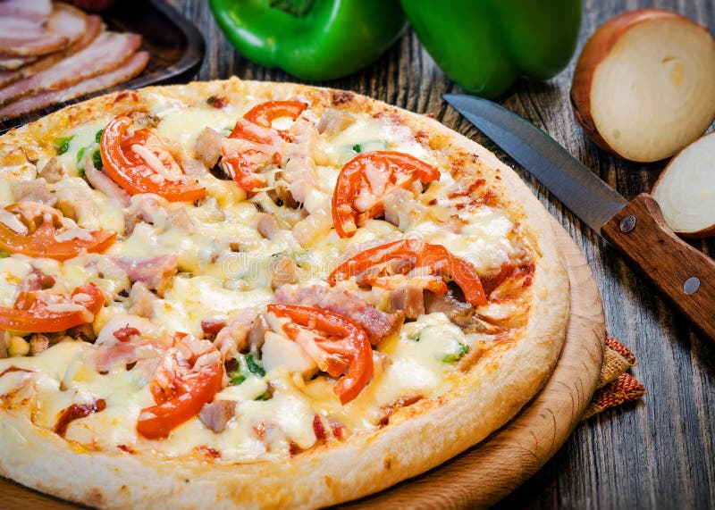 Small pizza with tomatoes stock image. Image of bread - 75007731