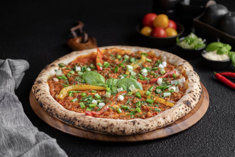 A Small Pizza on a Wooden Platter with a Variety of Toppings Stock ...